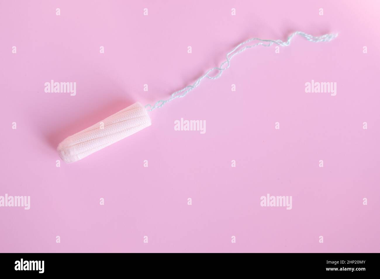 female tampon on a pink background. Hygienic white tampon for women ...