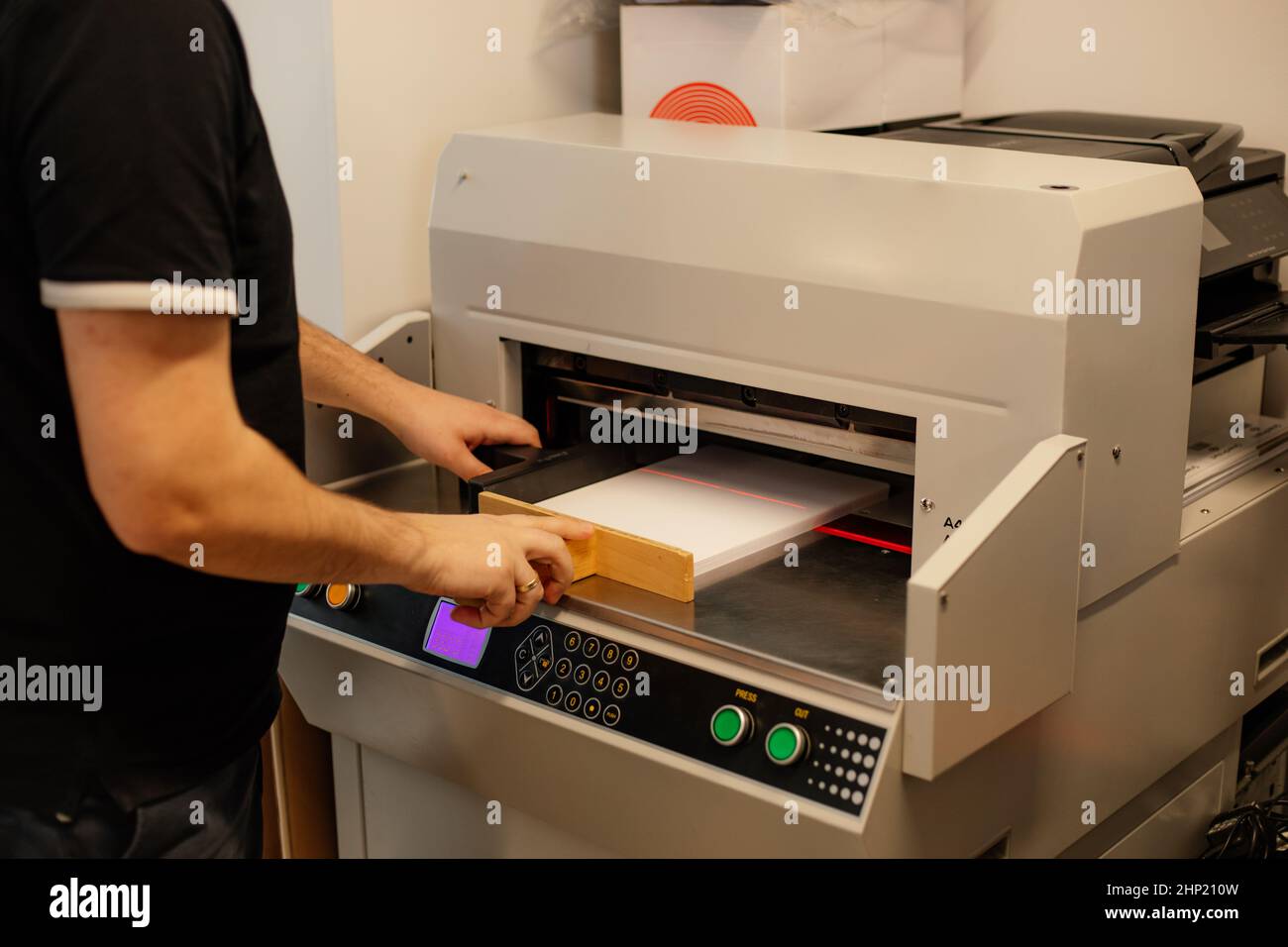 Cropped image man worker hands paper cutter machine, guillotine offset ...