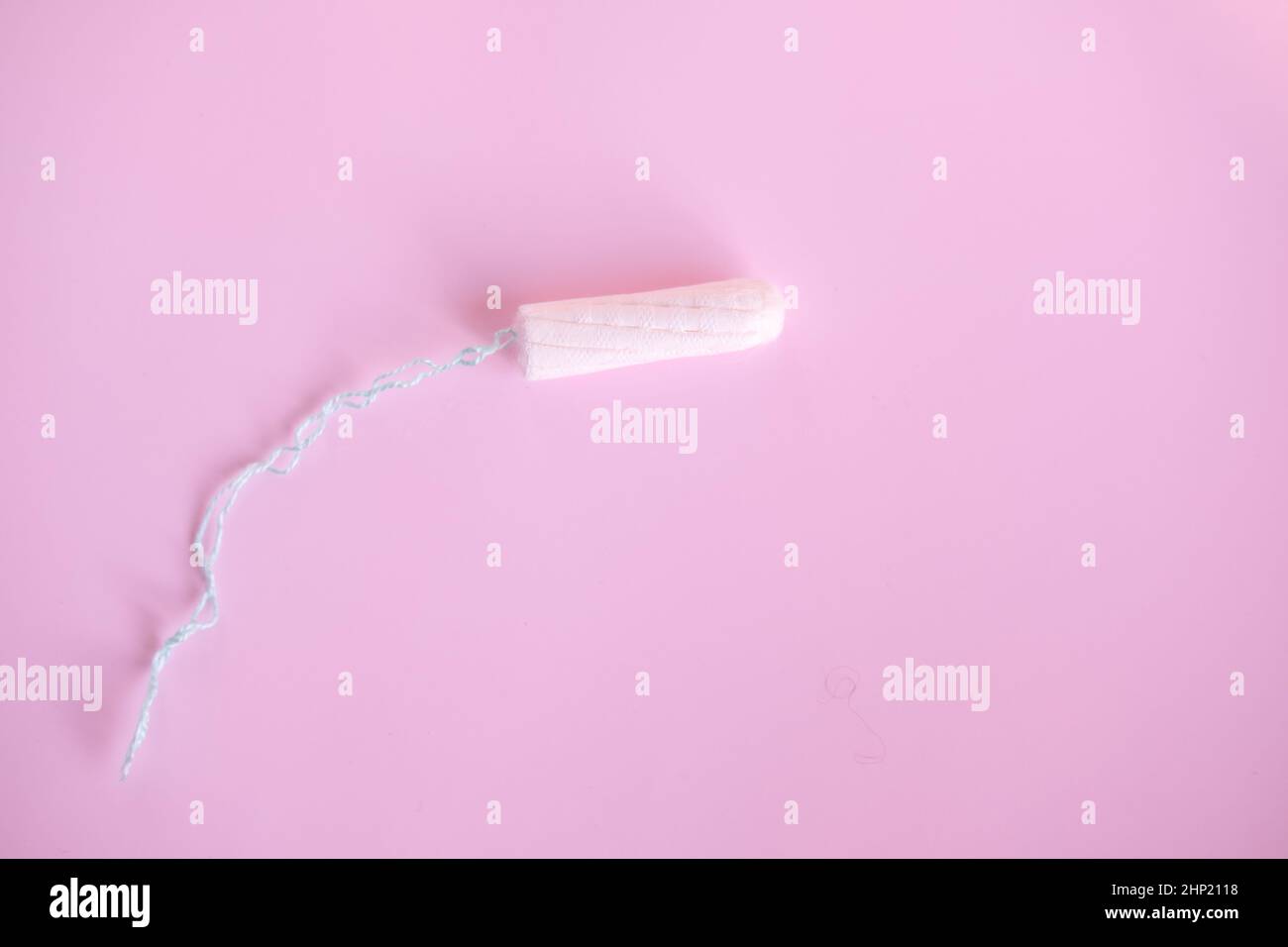 female tampon on a pink background. Hygienic white tampon for women ...