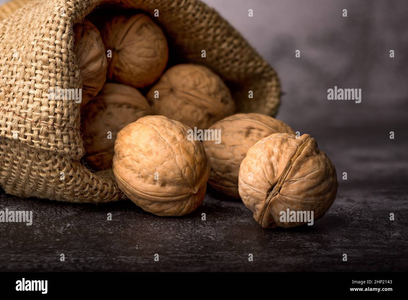 Whole walnuts in a sackcloth on a textured background Stock Photo - Alamy