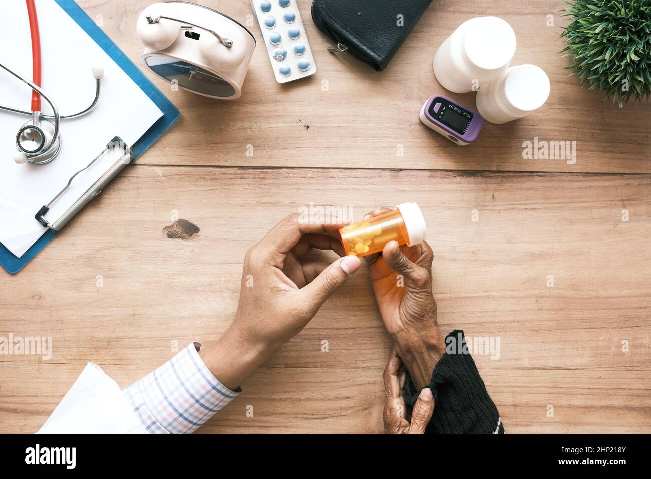 doctor giving a medical pill container his senior patient Stock Photo ...