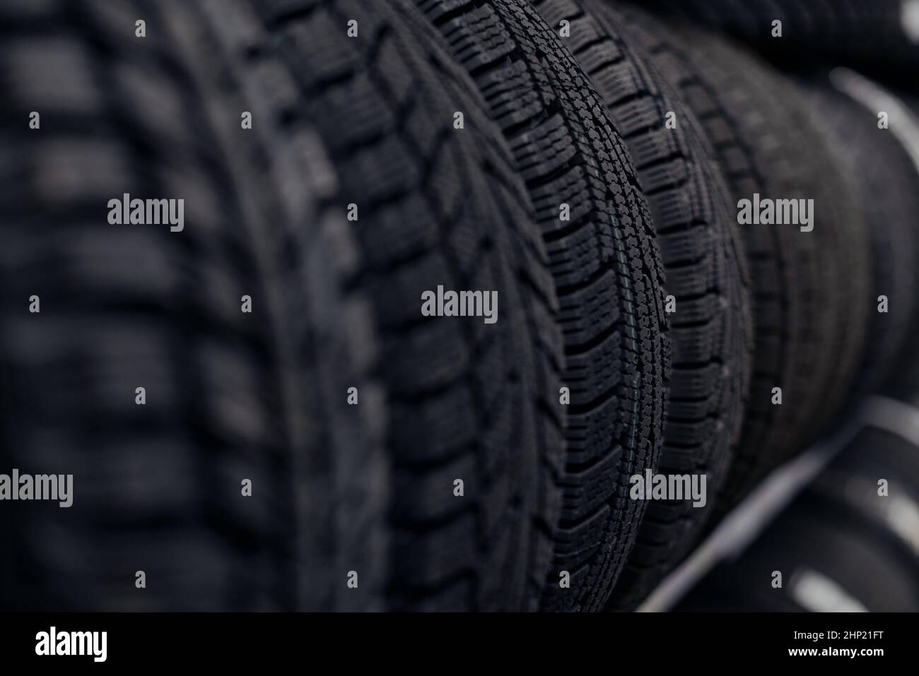 a lot of car tires on a rack in a car store Stock Photo - Alamy