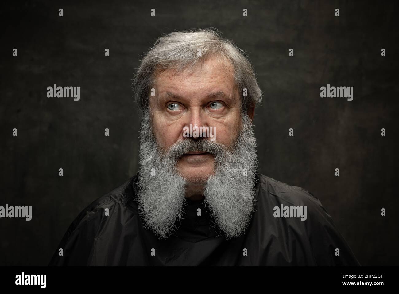 Dramatic portrait of emotional senior bearded man getting beard ...