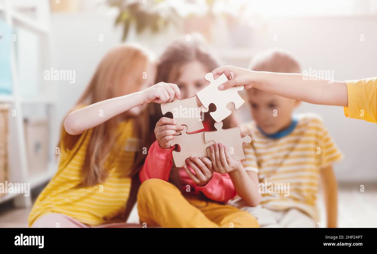Children playing together jigsaw puzzle hi-res stock photography and ...