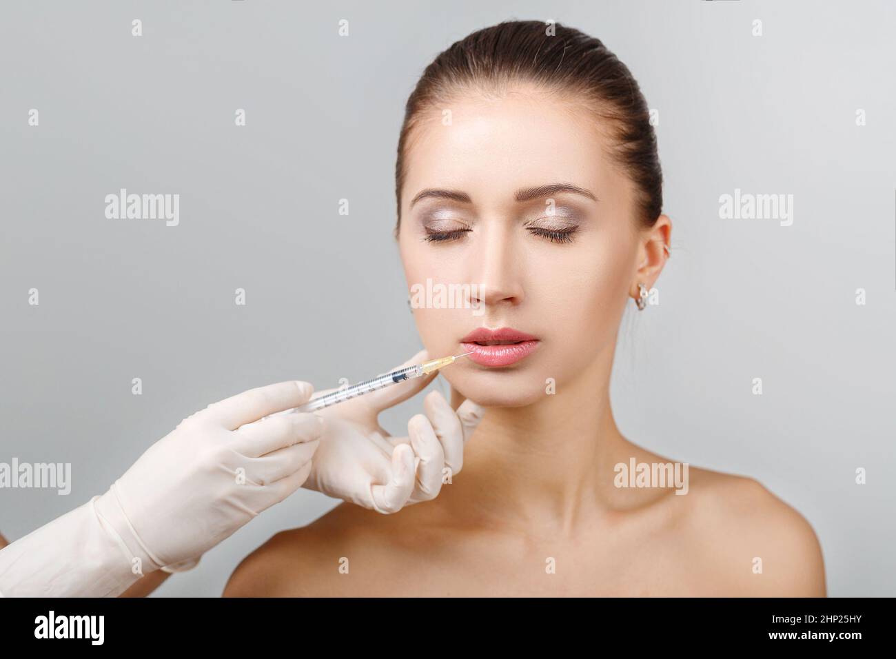 Portrait of young beautiful woman getting cosmetic lifting injection in ...