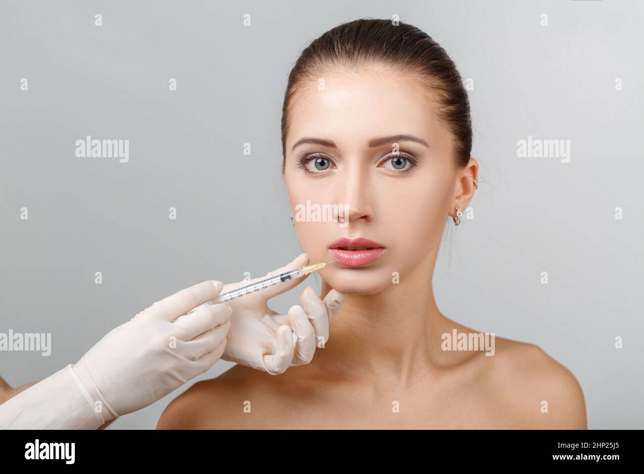 Portrait of young beautiful woman getting cosmetic lifting injection in ...