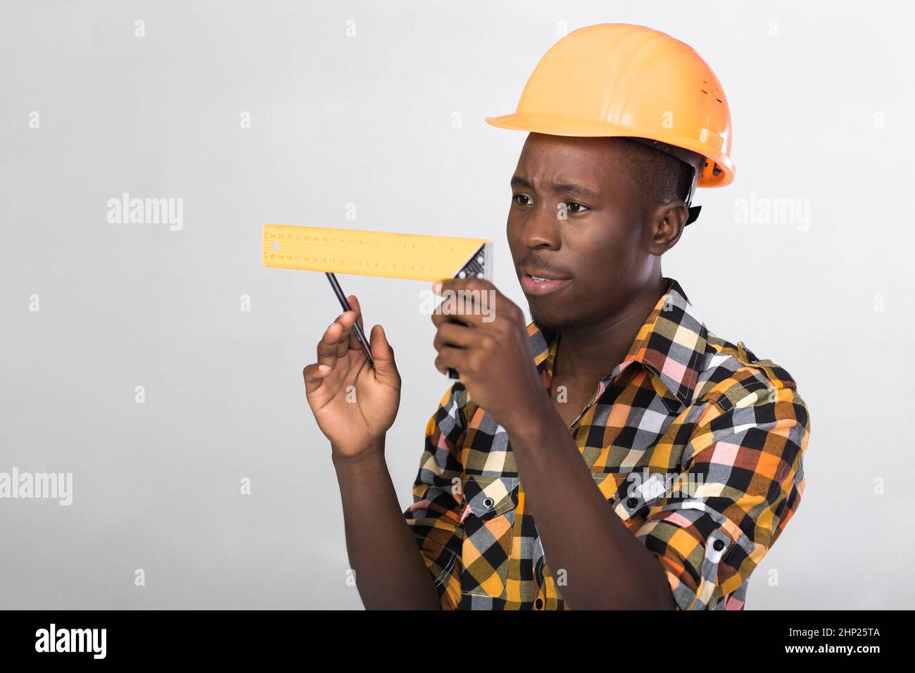 African American worker builder uses building ruler Stock Photo - Alamy