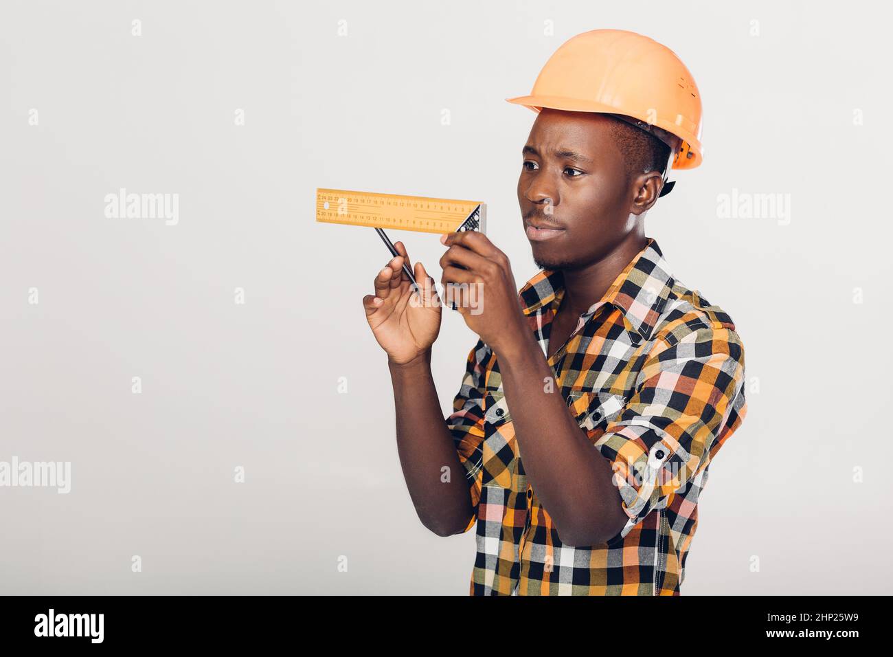 African American worker builder uses building ruler Stock Photo - Alamy