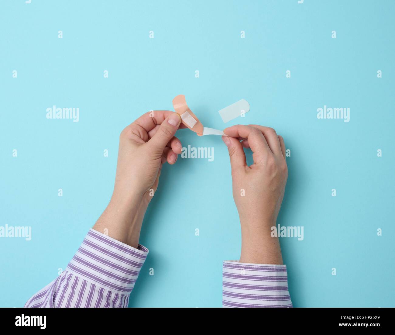 female hand and brown medical adhesive plaster for the treatment of ...