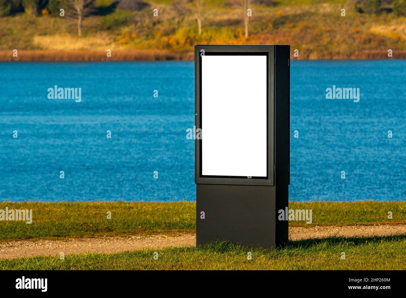 Blank billboard on a lake shore, banner with room to add your own text ...