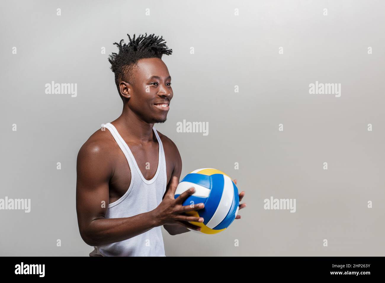 young athletic African-American man with volleyball ball Stock Photo ...