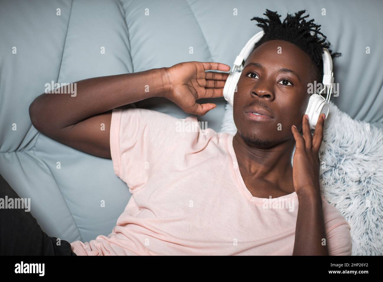 Black man resting on couch hi-res stock photography and images - Alamy