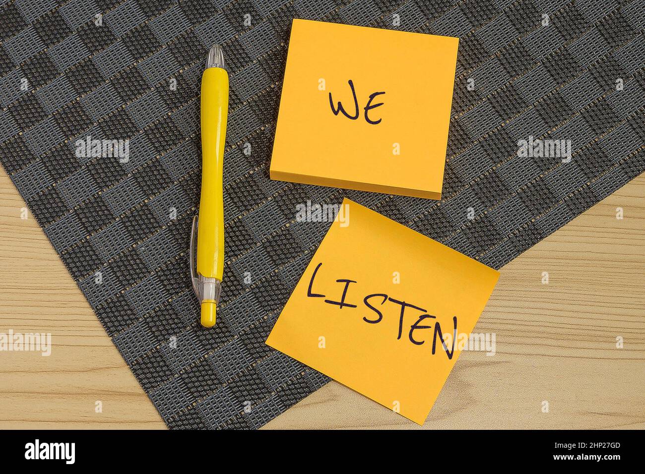 Text caption presenting We Listen, Word Written on Group of showing ...