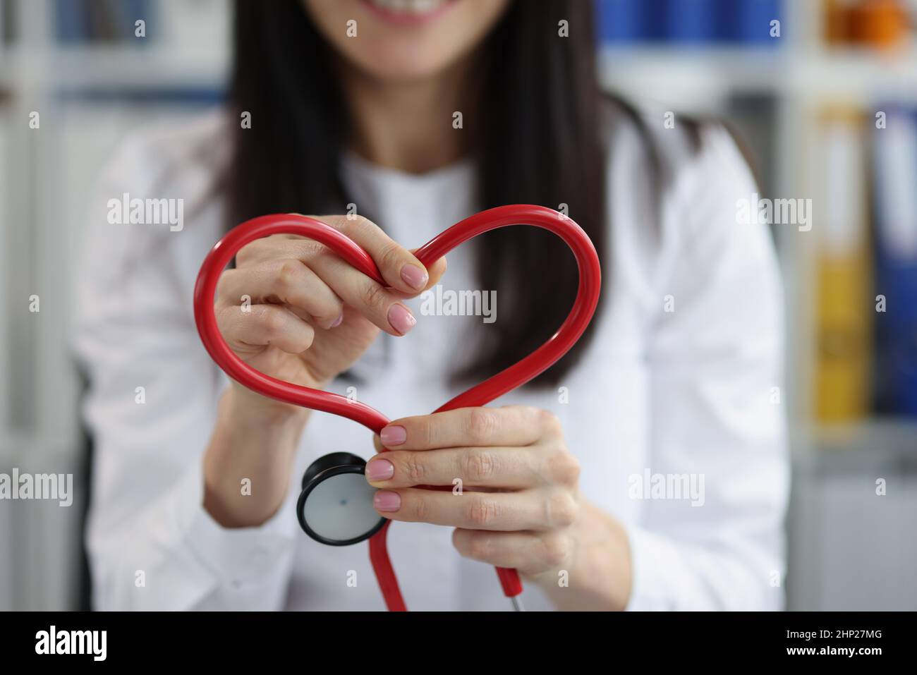 Woman doctor folded the figure heart from a stethoscope Stock Photo - Alamy