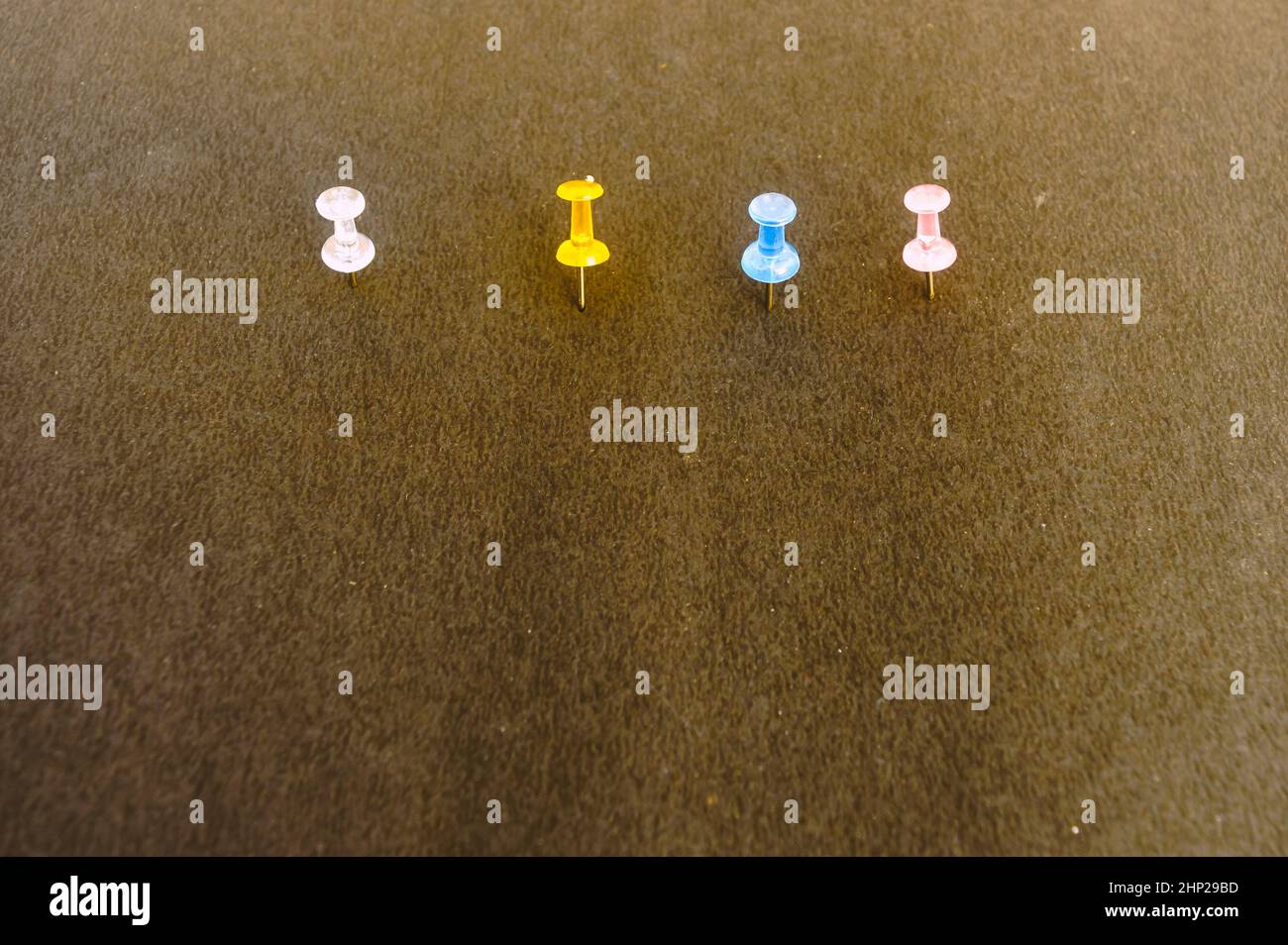 Notice Board Pin pinned attached on a brown color notice board on ...