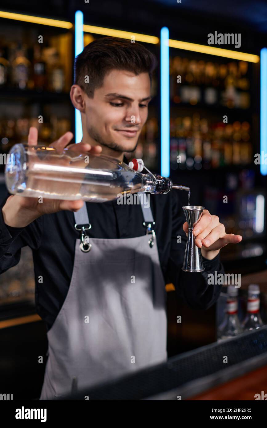 Bartender adds ingredients glass ice hi-res stock photography and ...