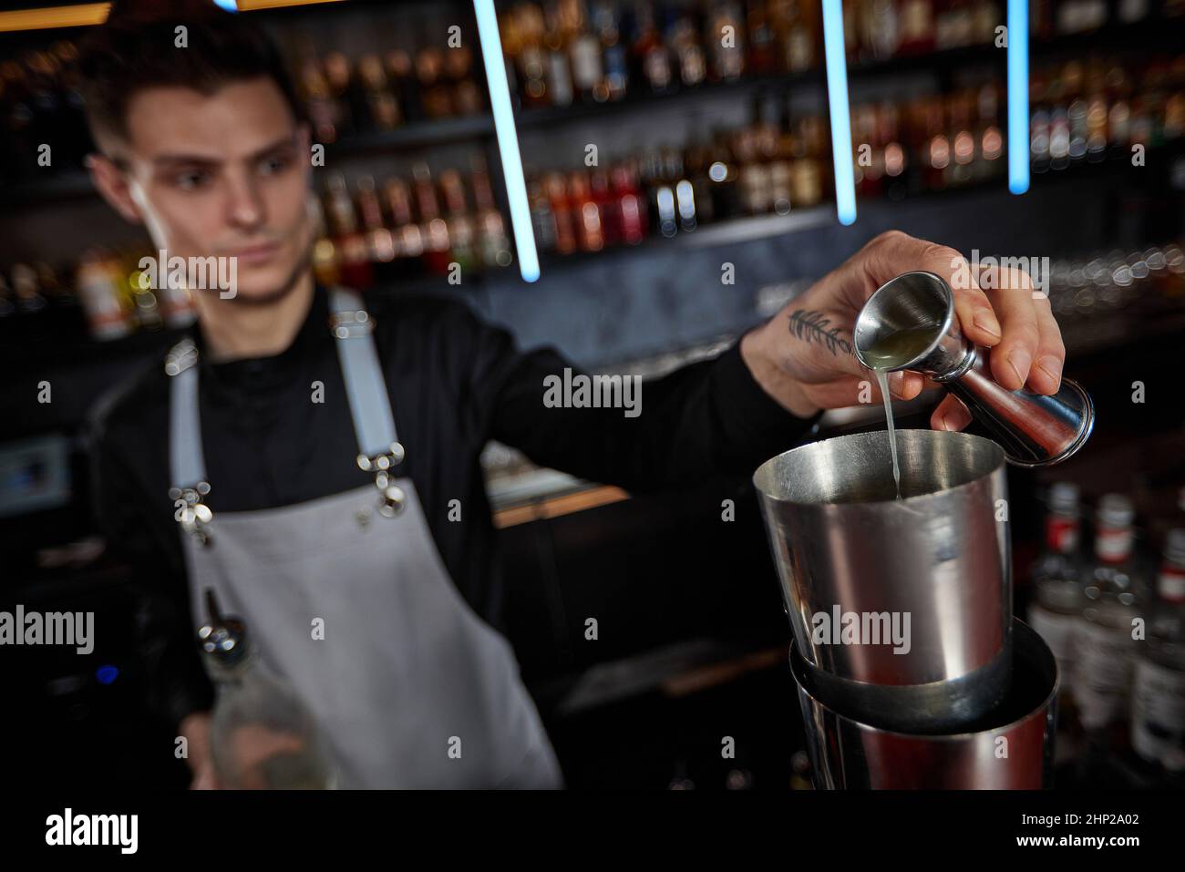 Bartender pouring cocktail from shaker hi-res stock photography and ...