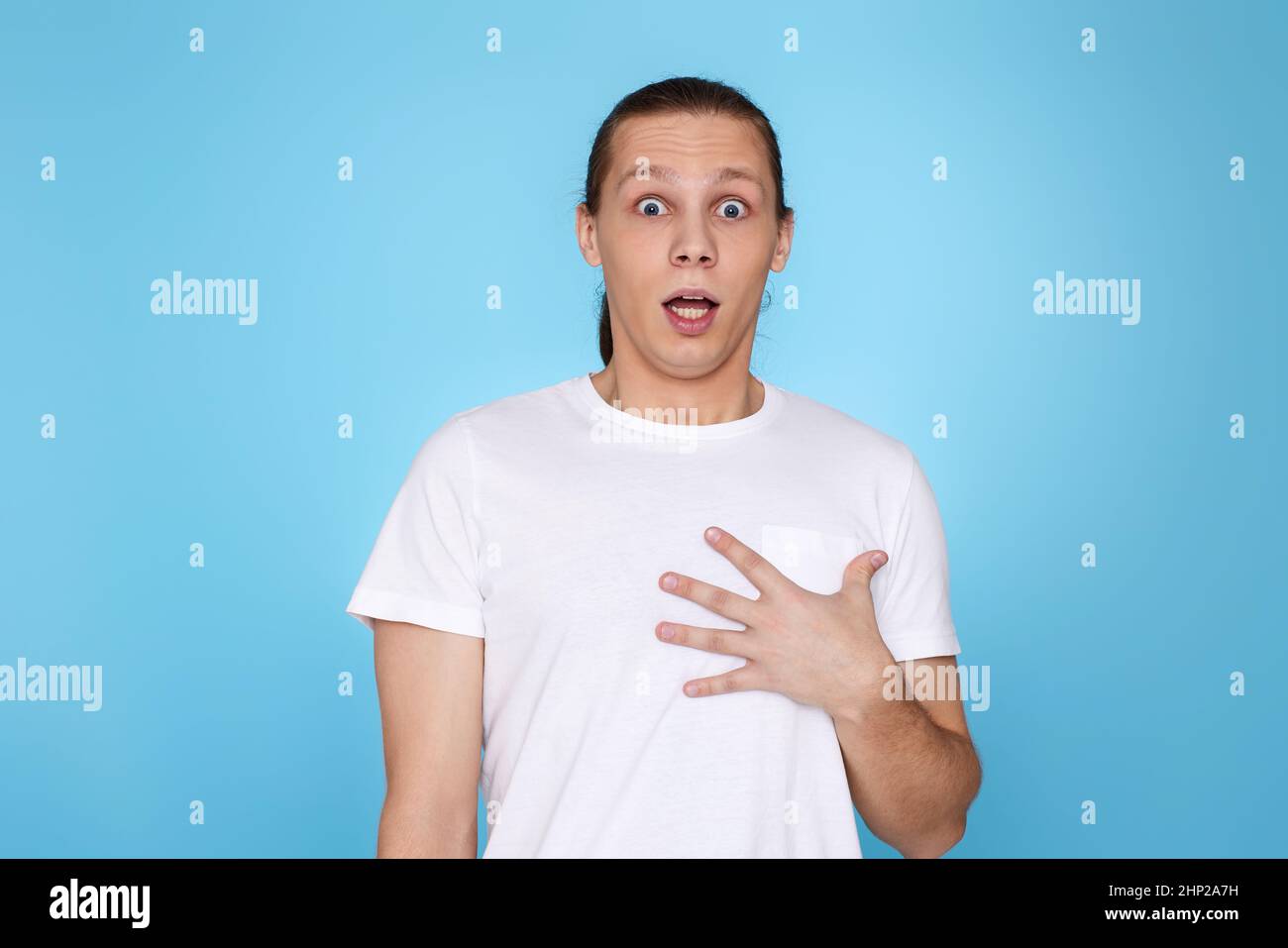 surprised young handsome guy isolated on blue background. Human ...