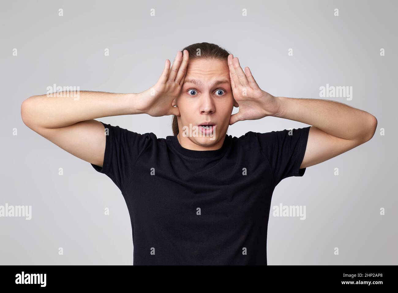 surprised young handsome guy isolated on gray background. Human ...