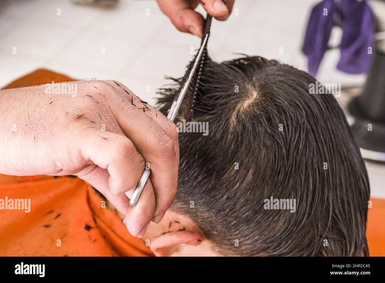 having a haircut at a male barber, a boy with a haircut, a barber and a ...