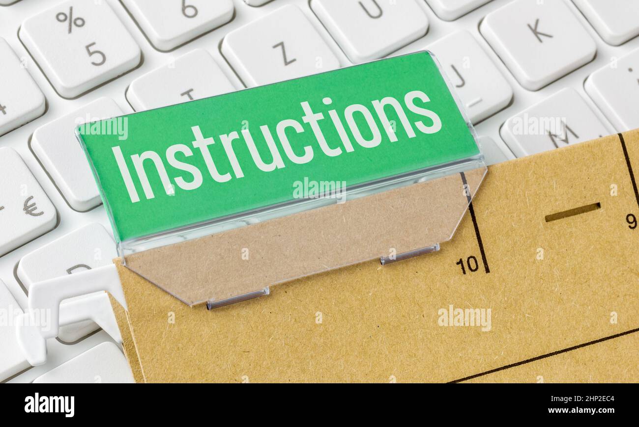 A brown file folder labeled Instructions Stock Photo - Alamy