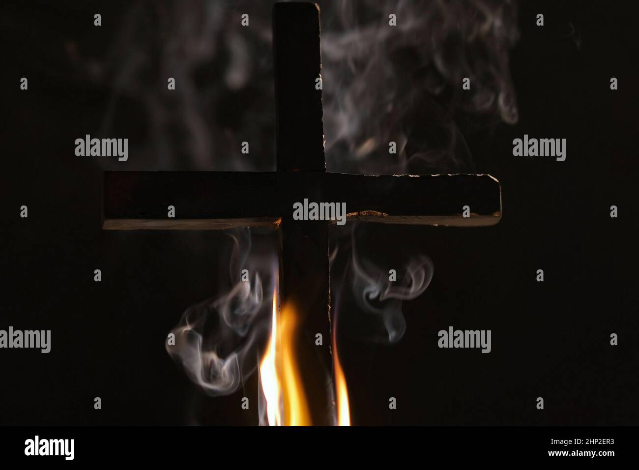 Burning cross with smoke in dark night Stock Photo - Alamy