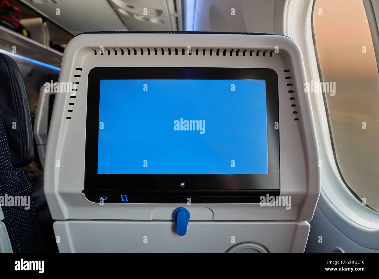 Using the seatback screen on a plane trip, watching movies, displaying ...