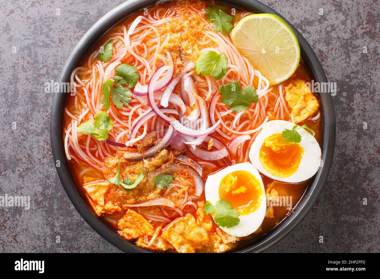 Mohinga is a fish soup prepared with rice noodles and flavored with ...