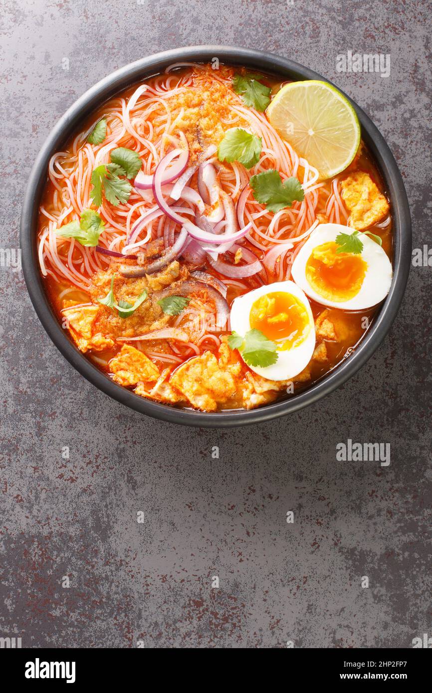 Burmese traditional or classic fish soup with white flat noodles called ...