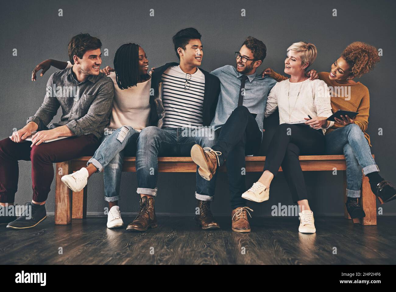 Bonding on the bench. Studio shot of a diverse group of creative ...