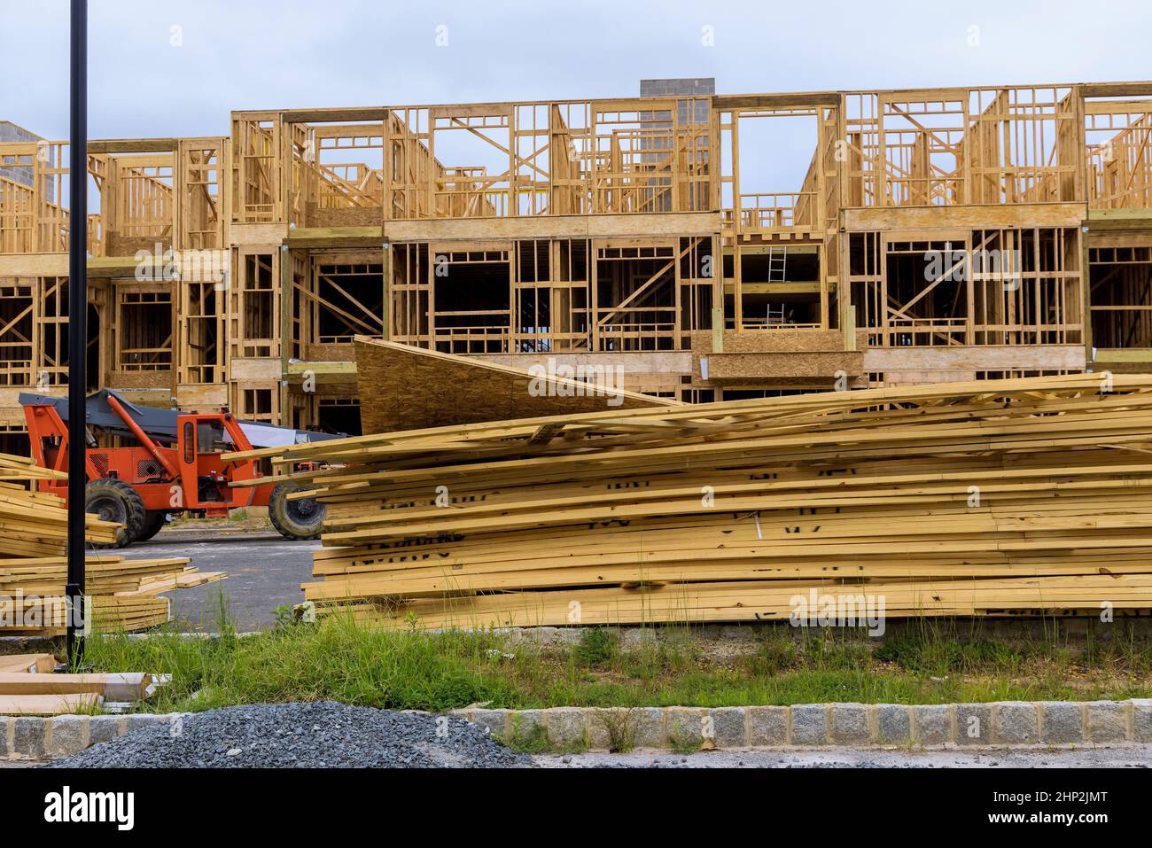 Wooden construction materials near under construction site with new ...