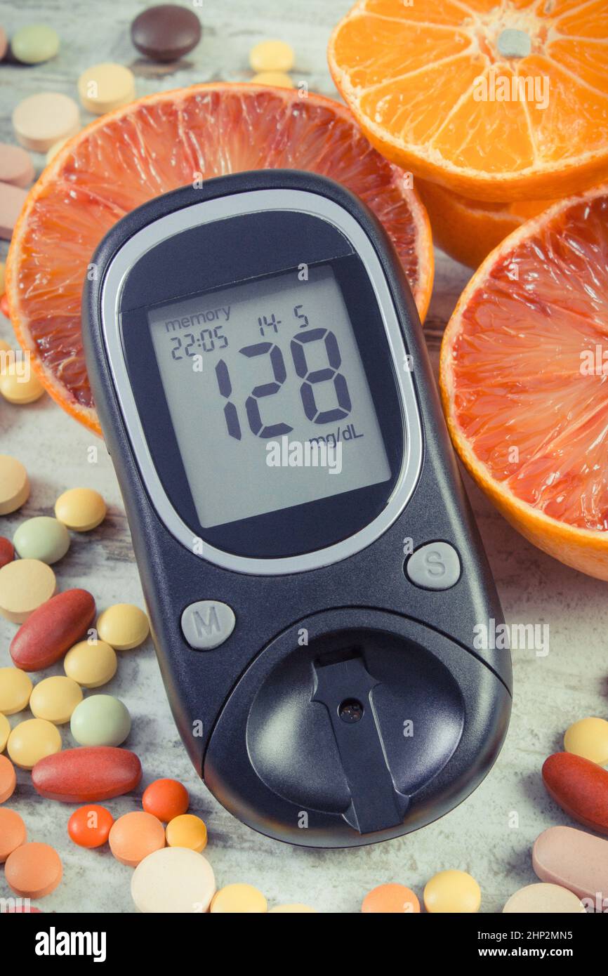 Glucometer for checking sugar level, fresh natural fruits and medical ...