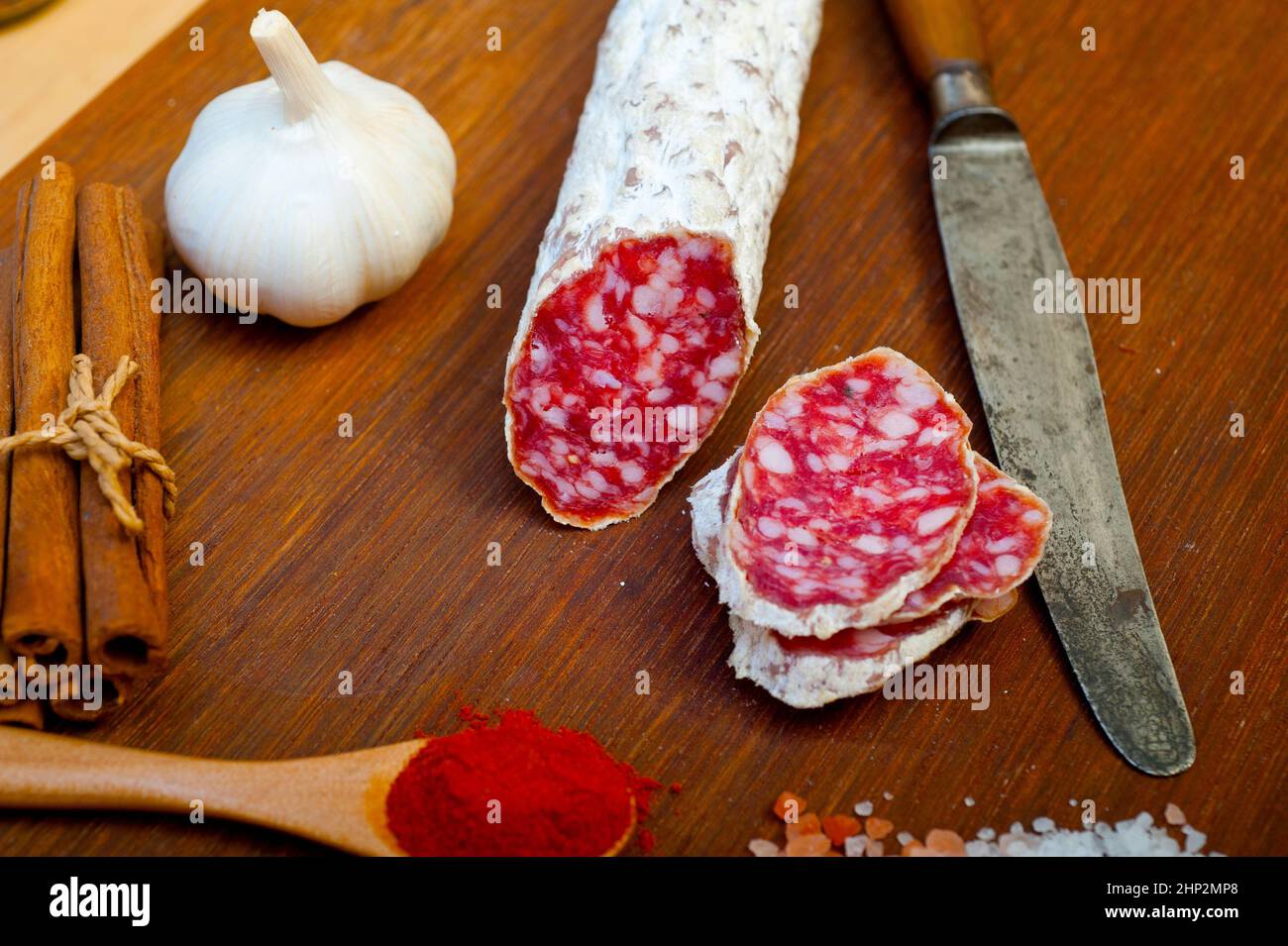 traditional Italian salame cured sausage sliced on a wood board Stock ...