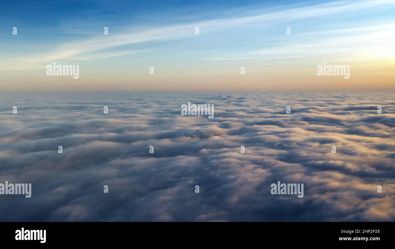 Above the clouds, sunrise or sunset. Clear sky over the fog. View from ...