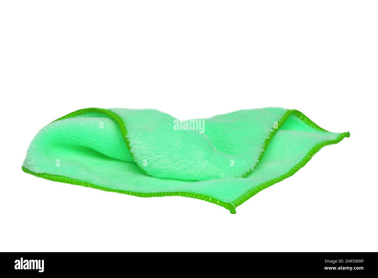 Household cleanliness and hygiene. Close-up of a green cleaning cloth ...