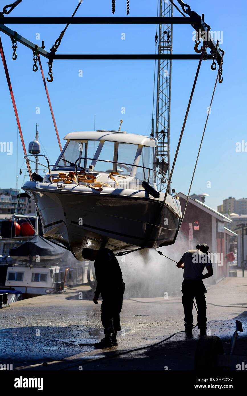 Two people washing a boat Stock Photo - Alamy