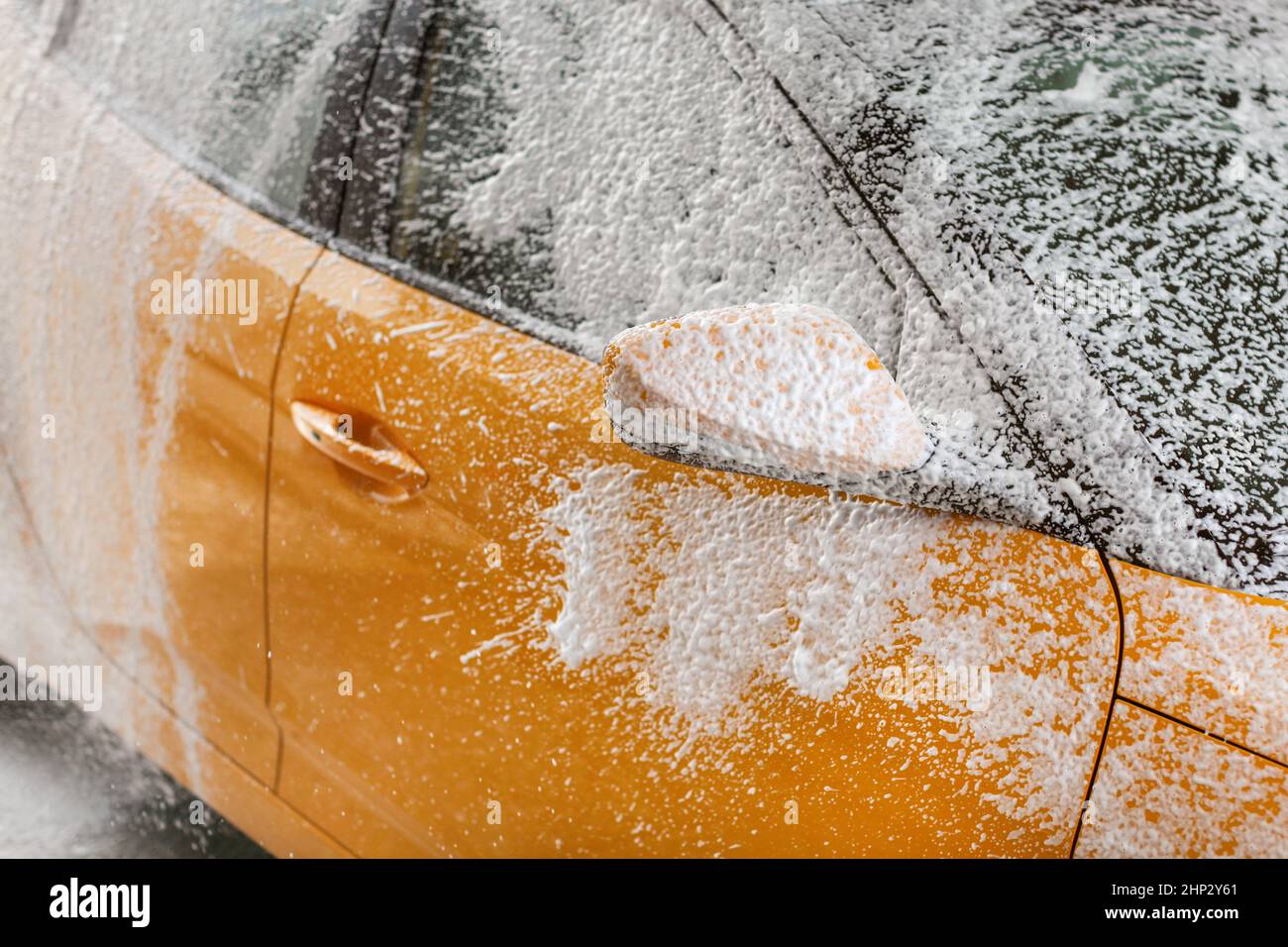 Side of a car, washed in self serve carwash, wind shield and mirror ...