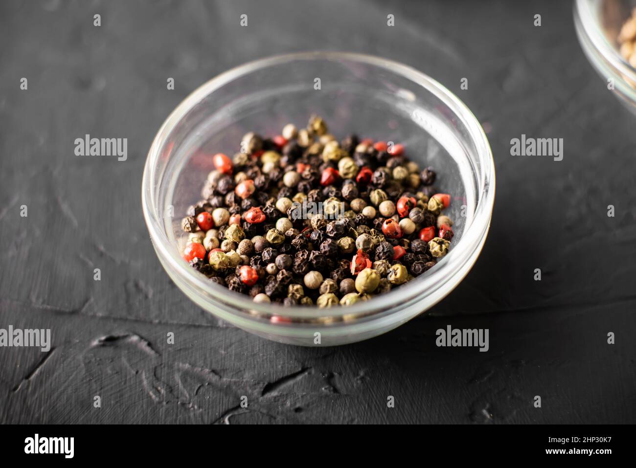 Multi-colored peppers in a bowl. Dark background. Close-up Stock Photo ...