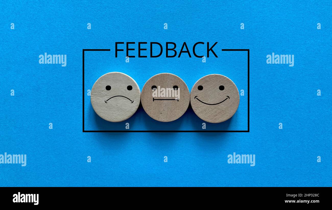 Feedback text on blue background with 3 wooden circle. Business concept ...