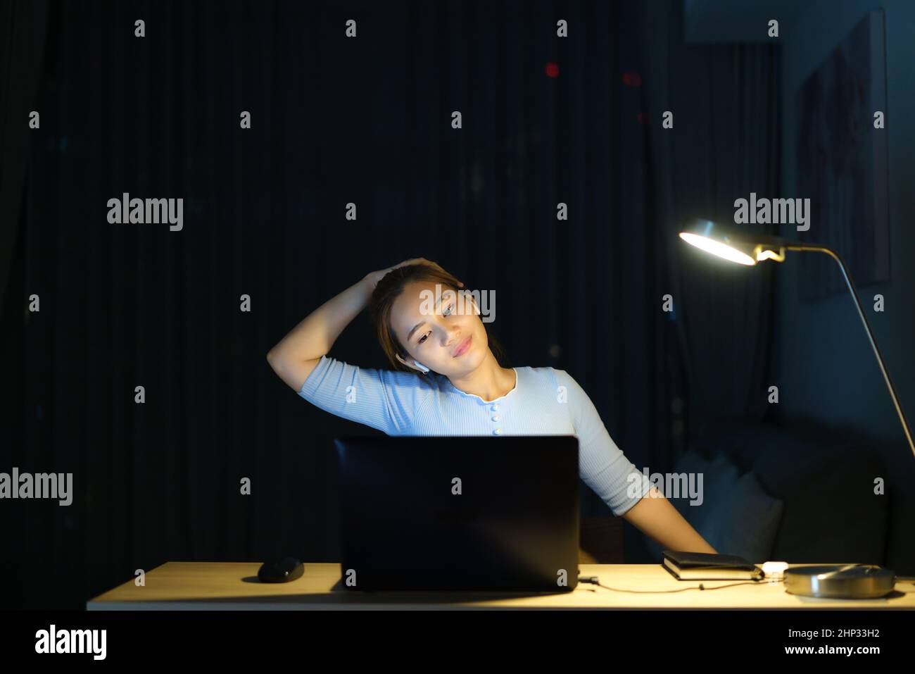 Asian woman are stretch lazily while working long hours in front of a ...