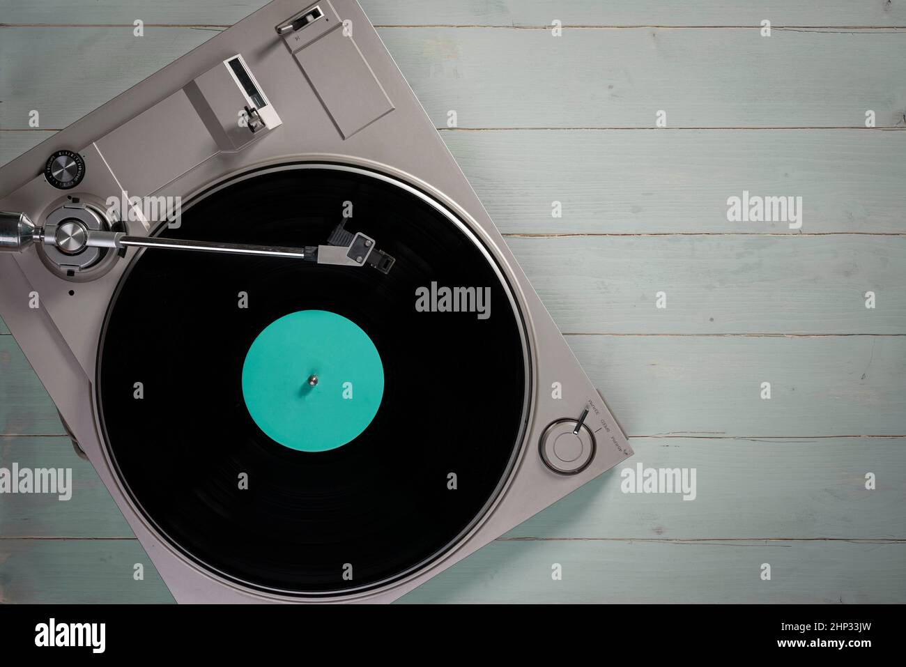 Gramophone with a vinyl record on wooden table, top view and copy space ...