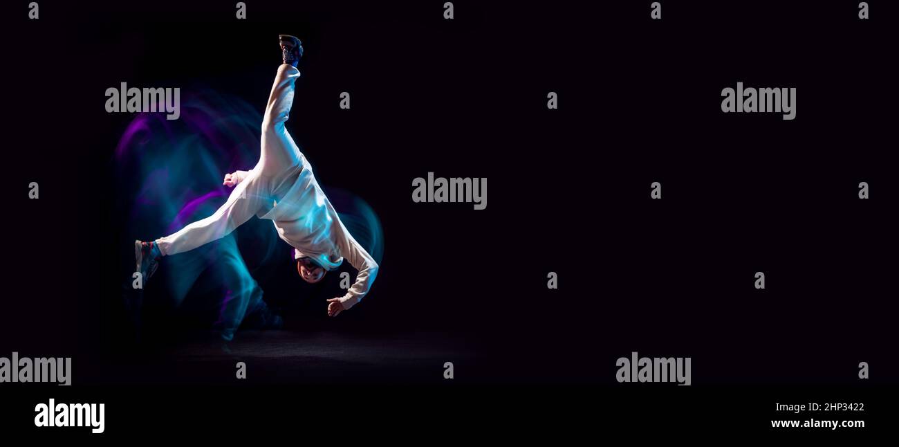 Hand stand. One energy young flexible sportive man dancing hip-hop or ...