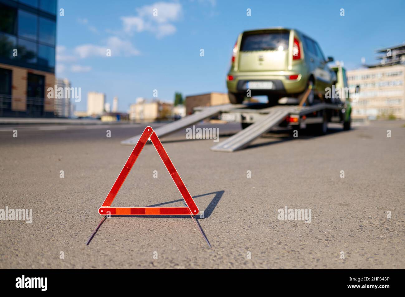 Red warning foldable triangle placed before tow track. Caution road ...