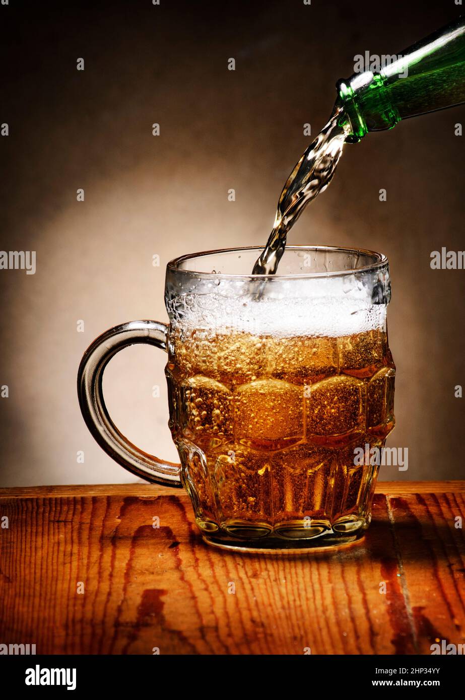 Pouring beer into beer mug Stock Photo - Alamy