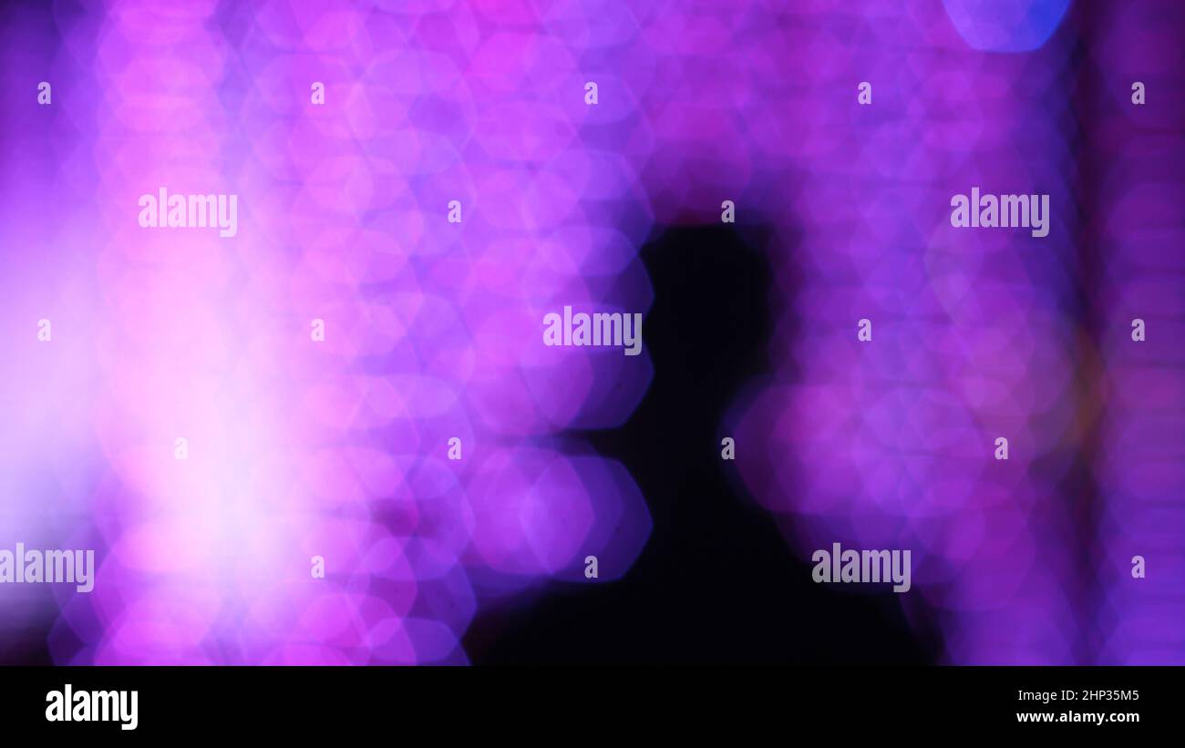 Blurry silhouette man with bokeh, festival lighting background Stock Photo - Alamy
