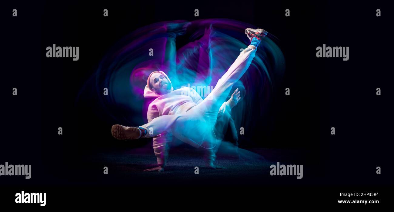 One energy young flexible sportive man dancing hip-hop or breakdance in ...