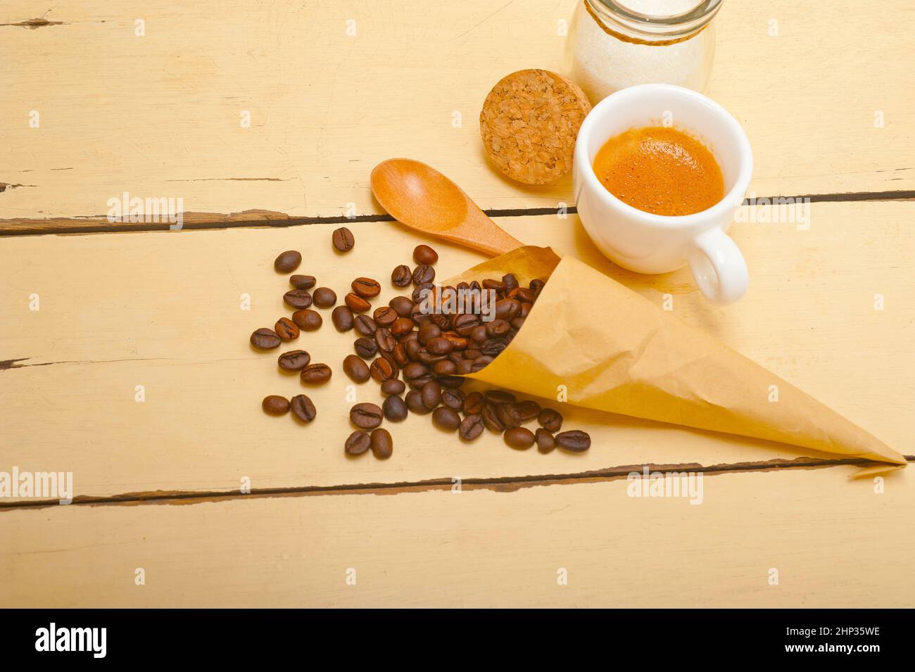 espresso coffee and beans on a paper cone cornucopia over white ...