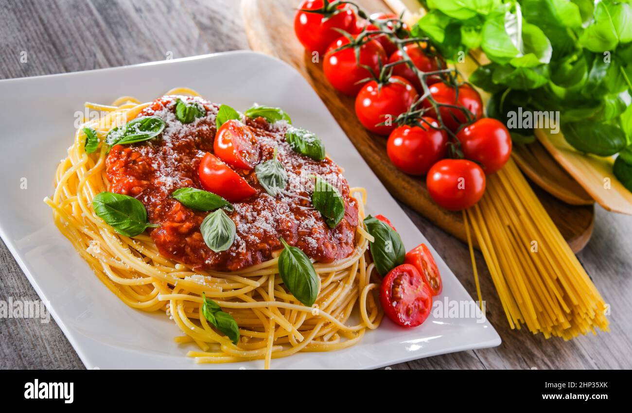 Composition with a plate of spaghetti bolognese Stock Photo - Alamy