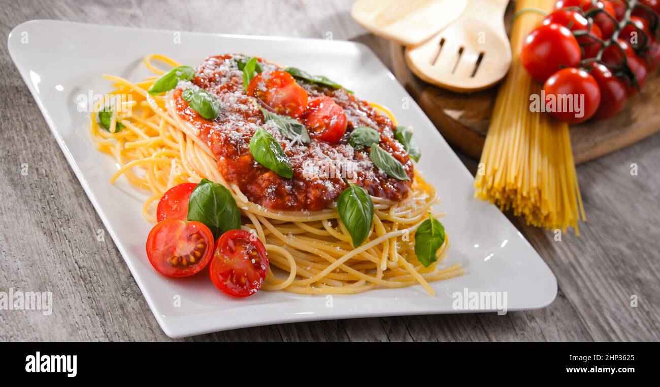 Composition with a plate of spaghetti bolognese Stock Photo - Alamy