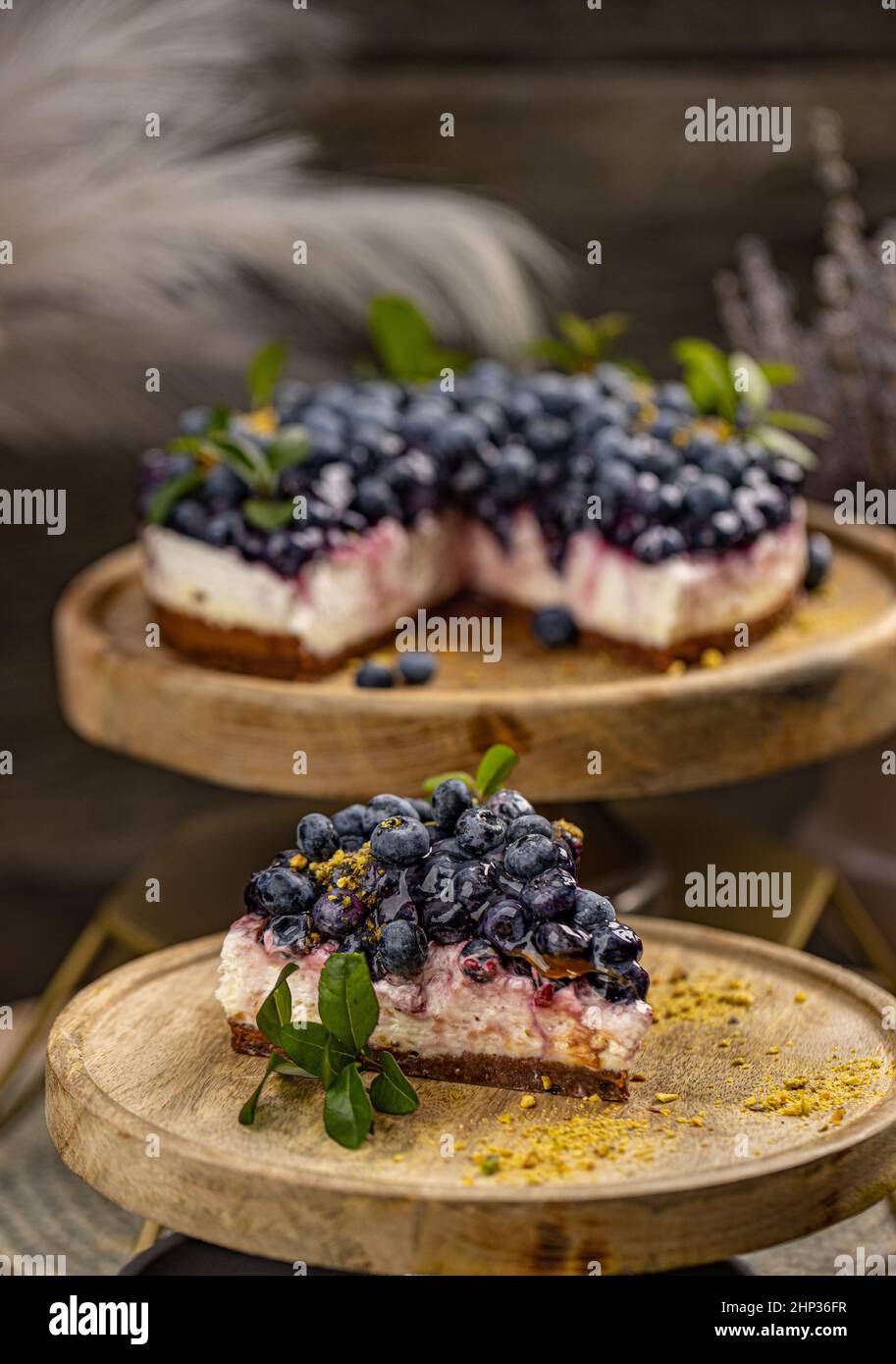 Cheesecake with blueberries on top, triangle slice on cake stand Stock ...